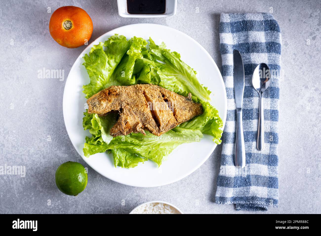 Fried "peroa" fish, lettuce salad, tomato, lemon, rice, beans and ...