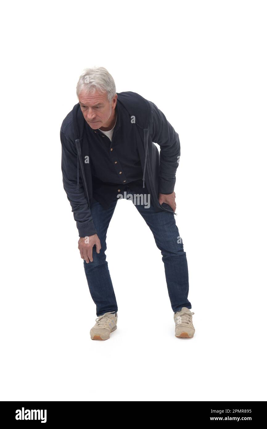 full length front view portrait of a man crouching and looking into the ...