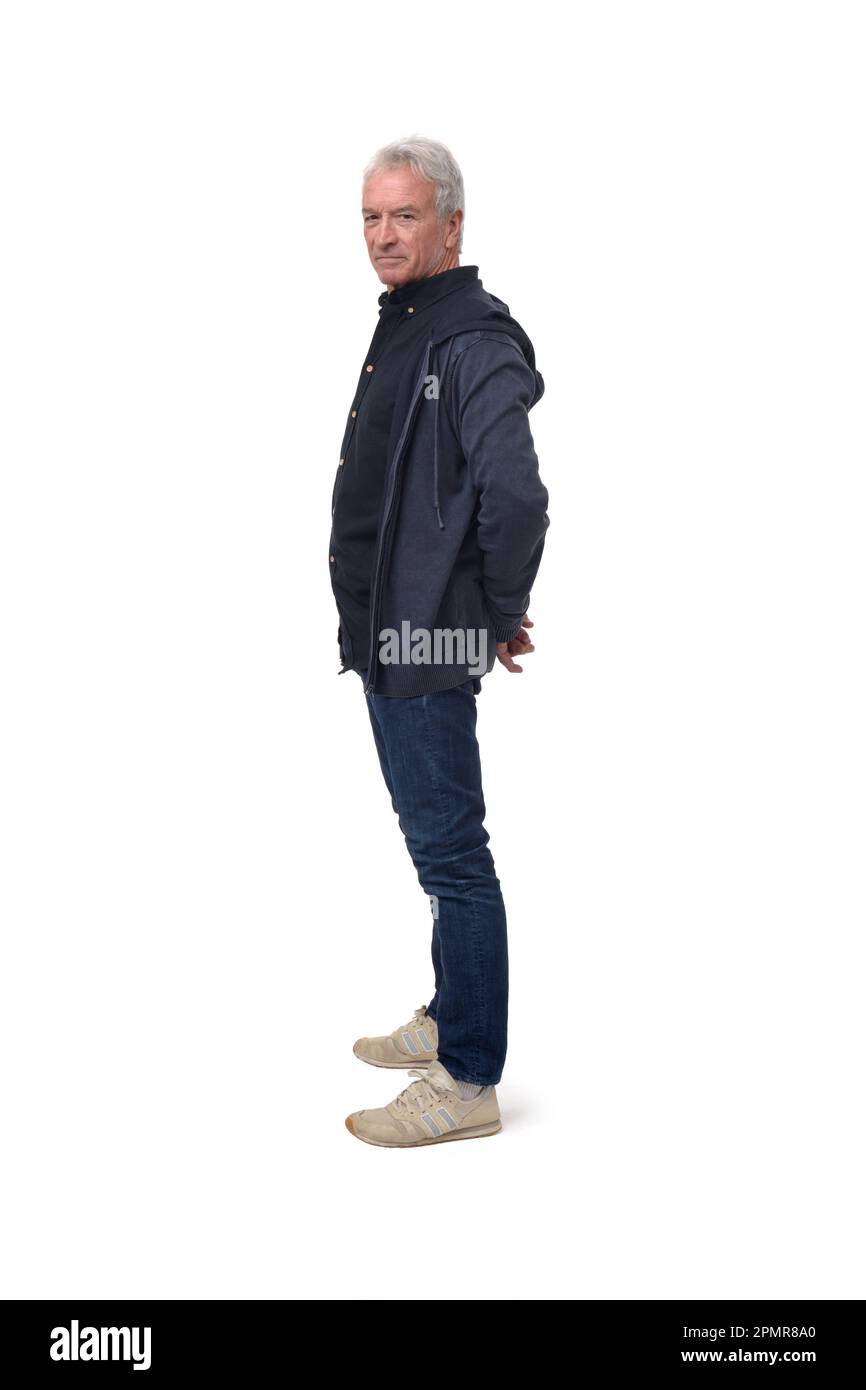 full length side view portrait of a man looking at camera and serious ...
