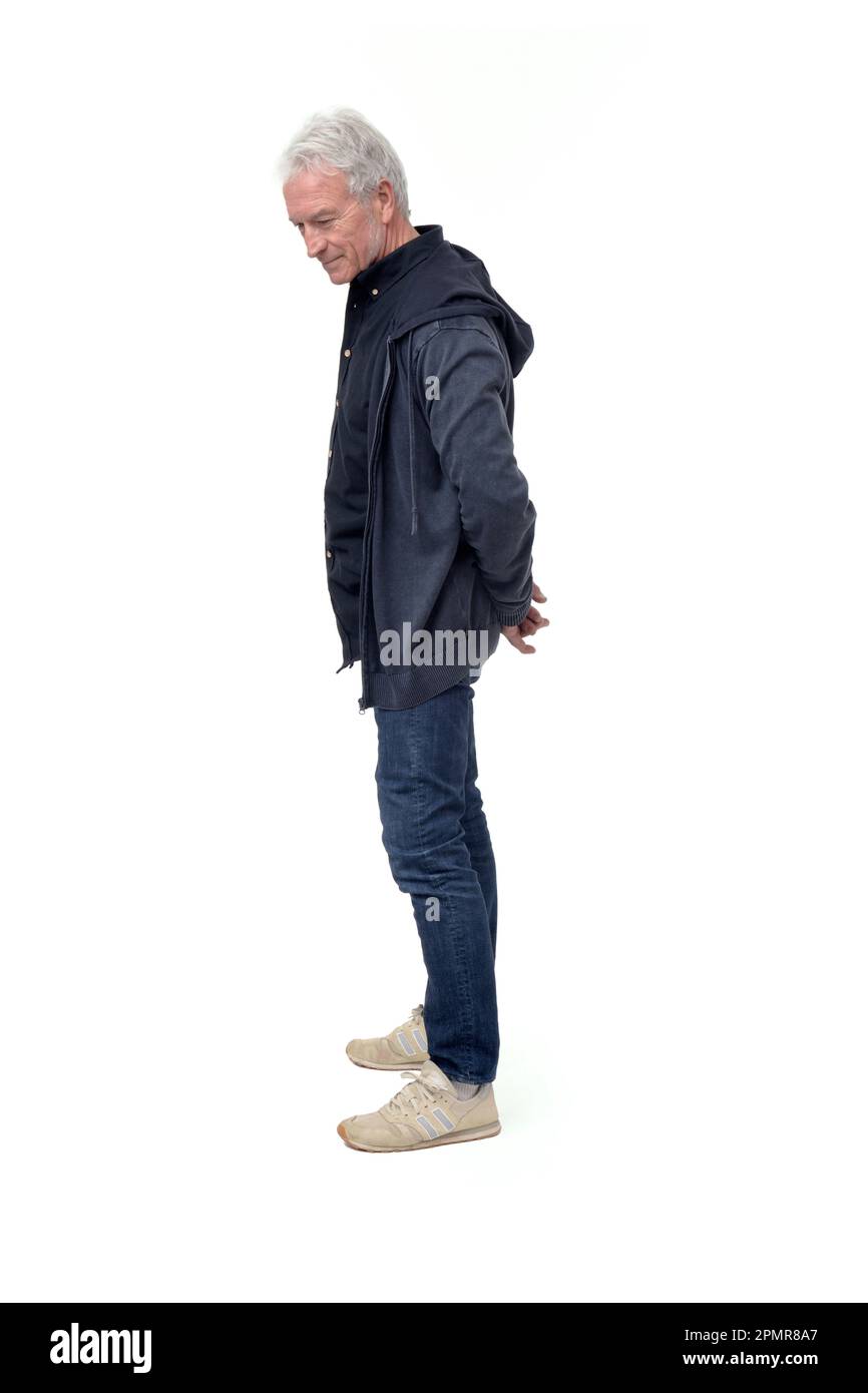 full length side view portrait of a man standing and looking down at ...