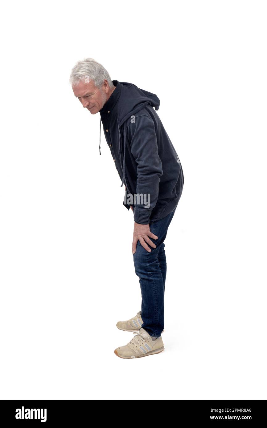 portrait of a side view of a man crouched down and looking the floor on ...