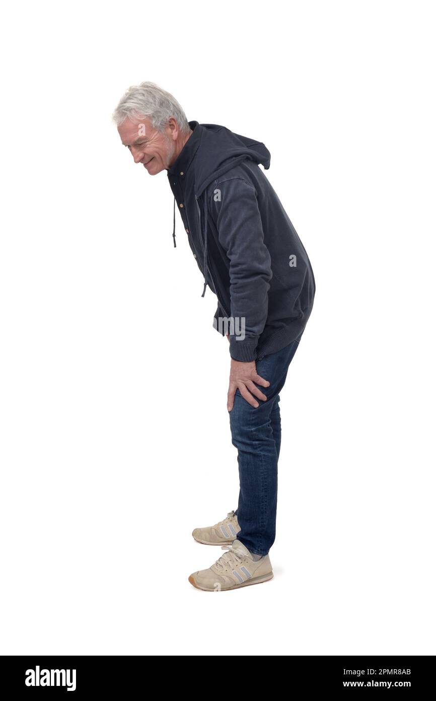 full portrait of side view of a man crouched down and looking the floor ...