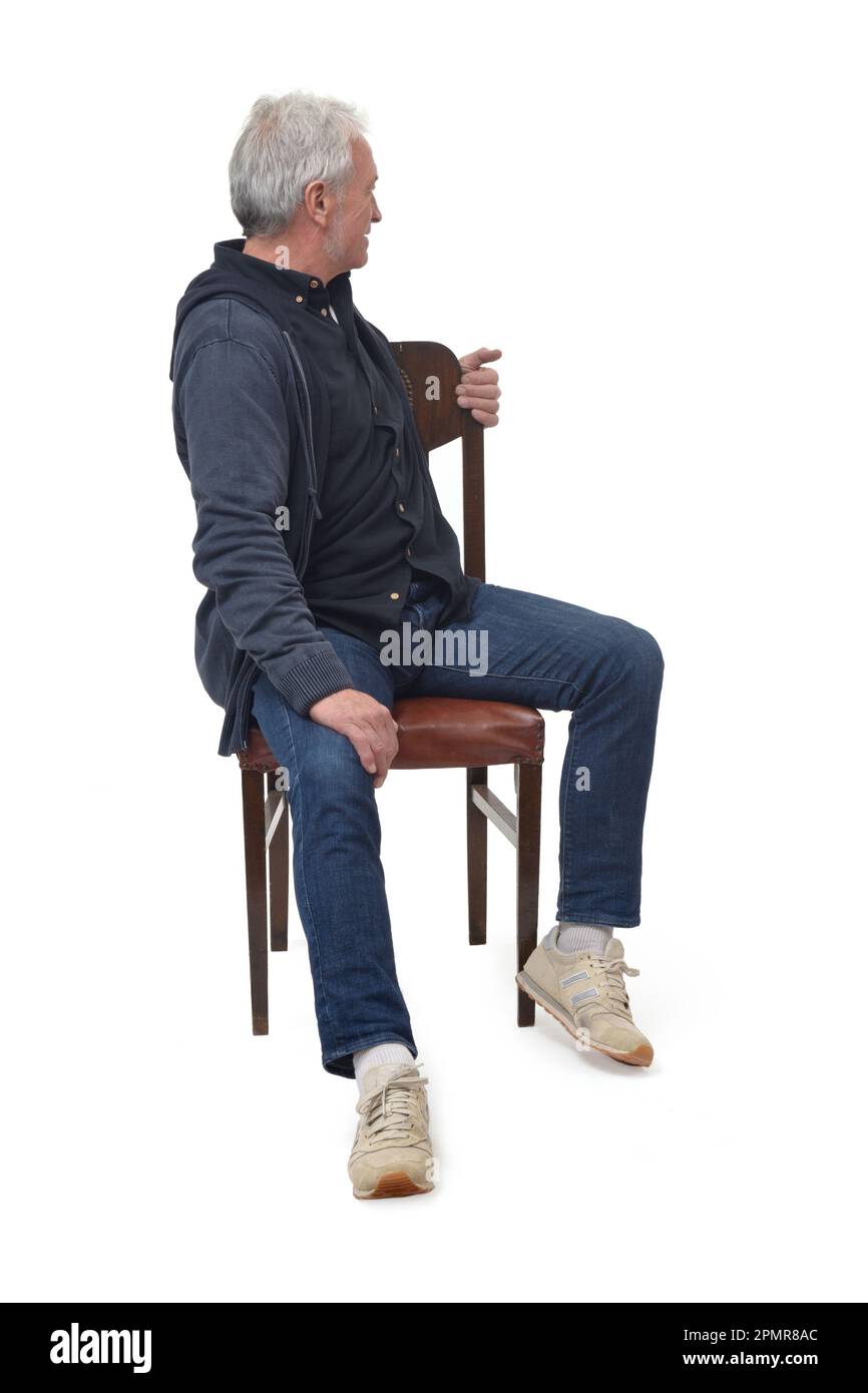 man sitting on a chair from the front who turns and looks into the ...