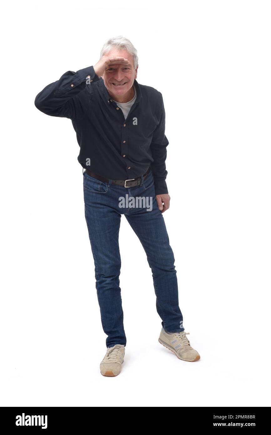 front view of standing man looking at camera with hand on forehead on ...