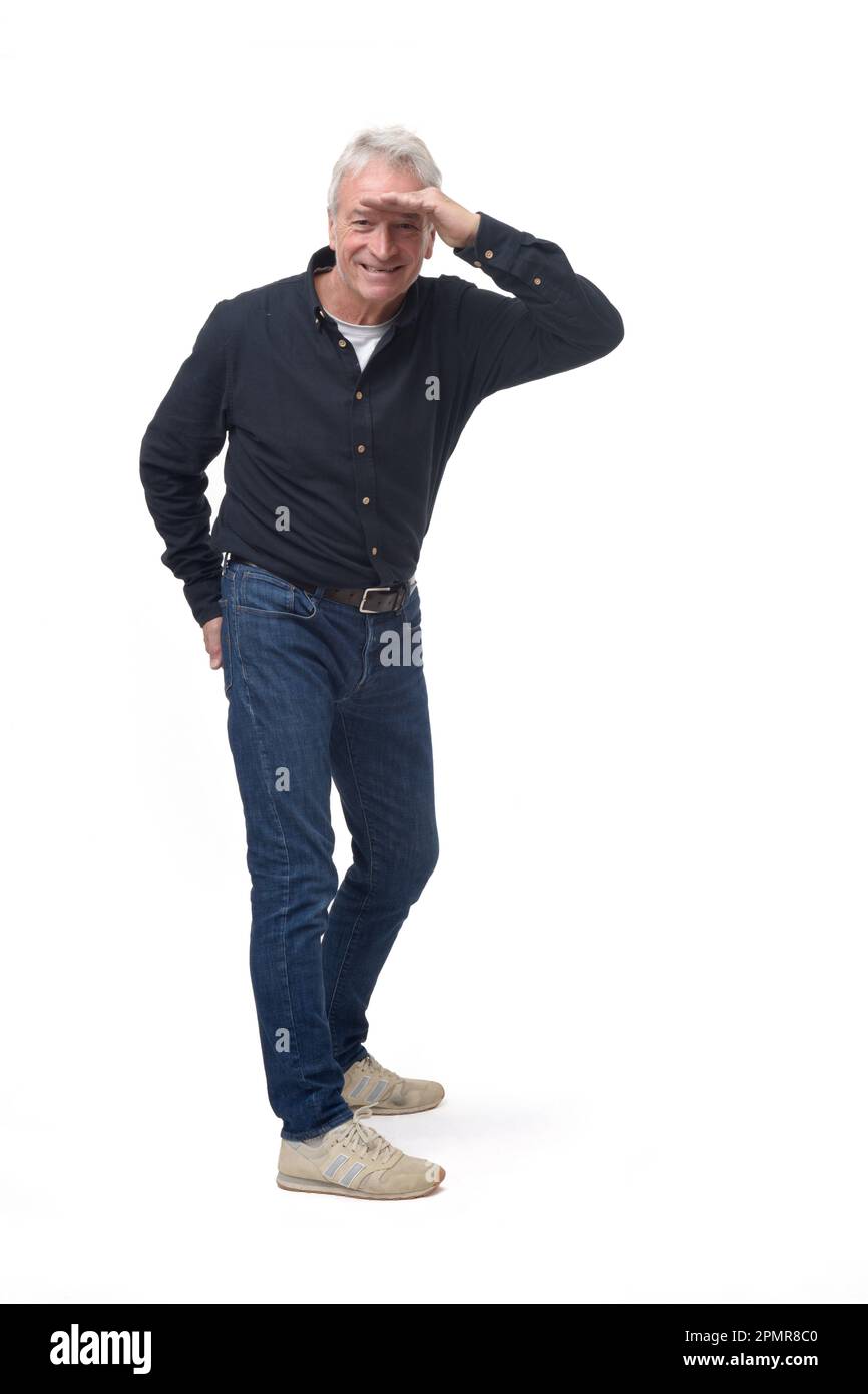 side view of standing man looking at camera with hand on forehead on ...