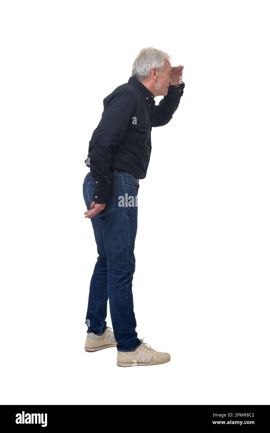 side view of standing man looking with hand on forehead on white ...