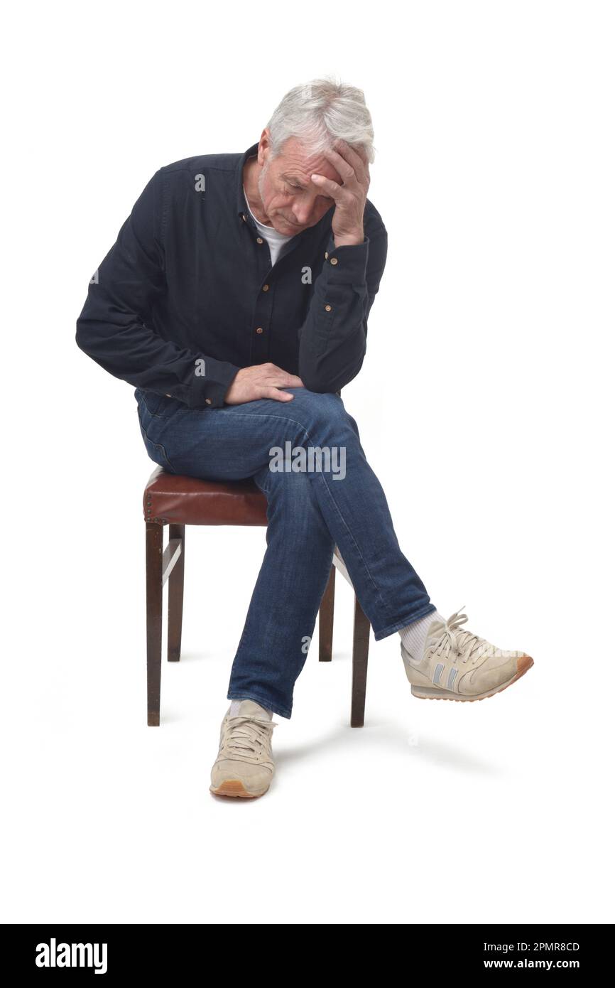 sad man sitting on chair on white background Stock Photo - Alamy