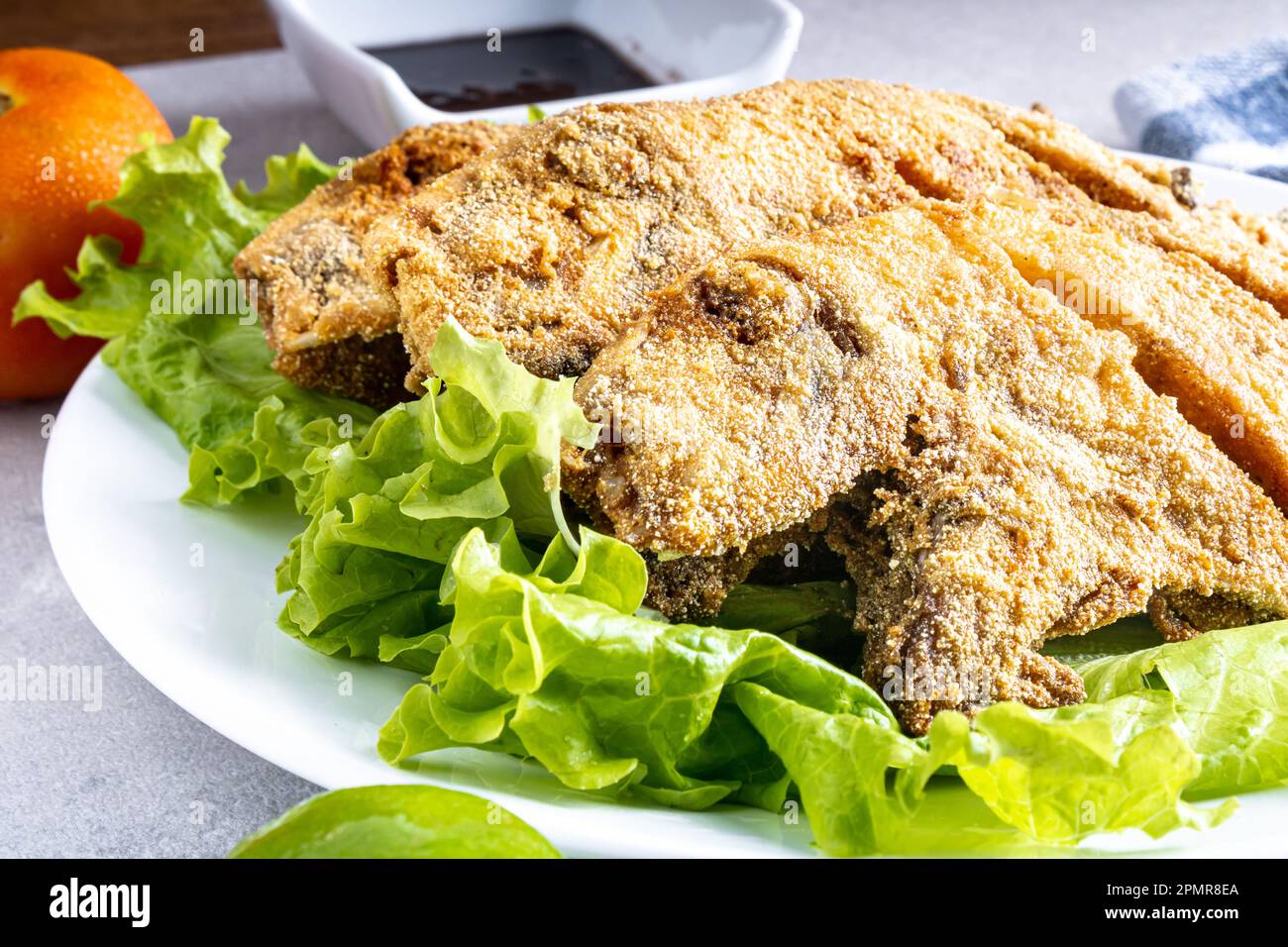 Fried "peroa" fish, lettuce salad, tomato, lemon, rice, beans and ...