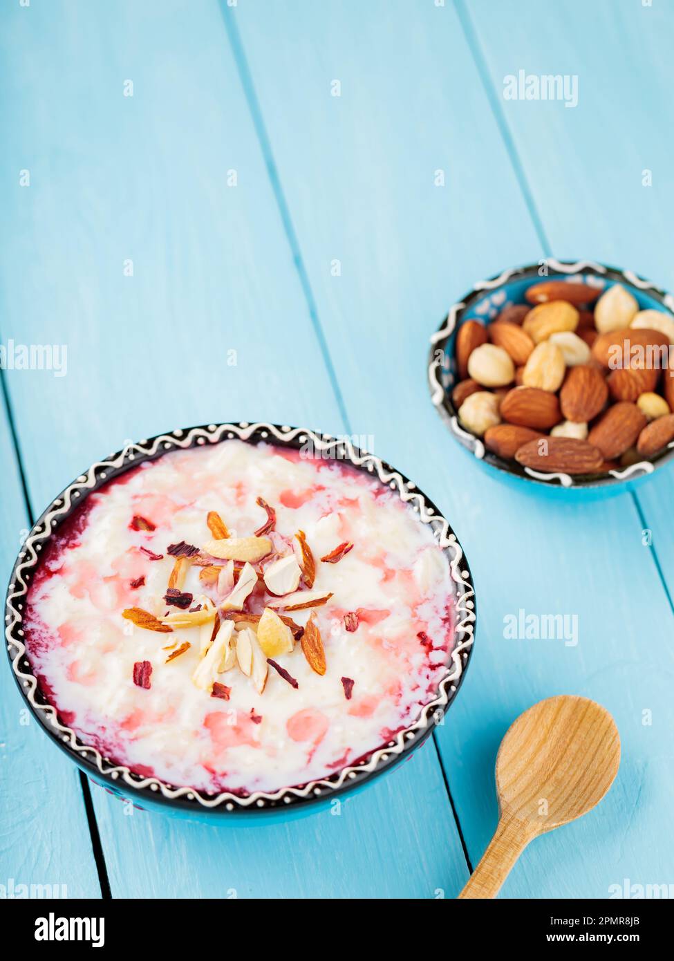 Delicious rice pudding with nuts and rose water. Bowl of indian kheer ...