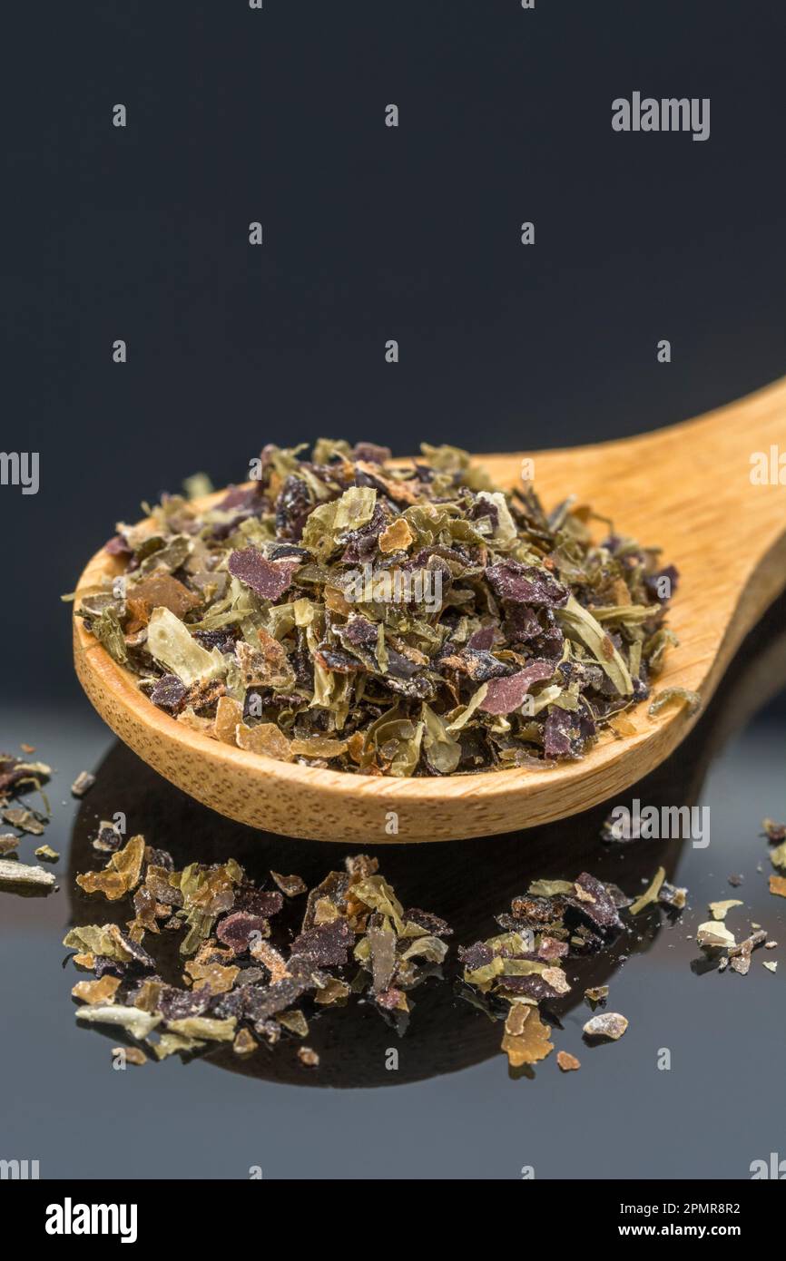 Bamboo spoon with milled dried seaweed - to be used as a savoury spicy ...