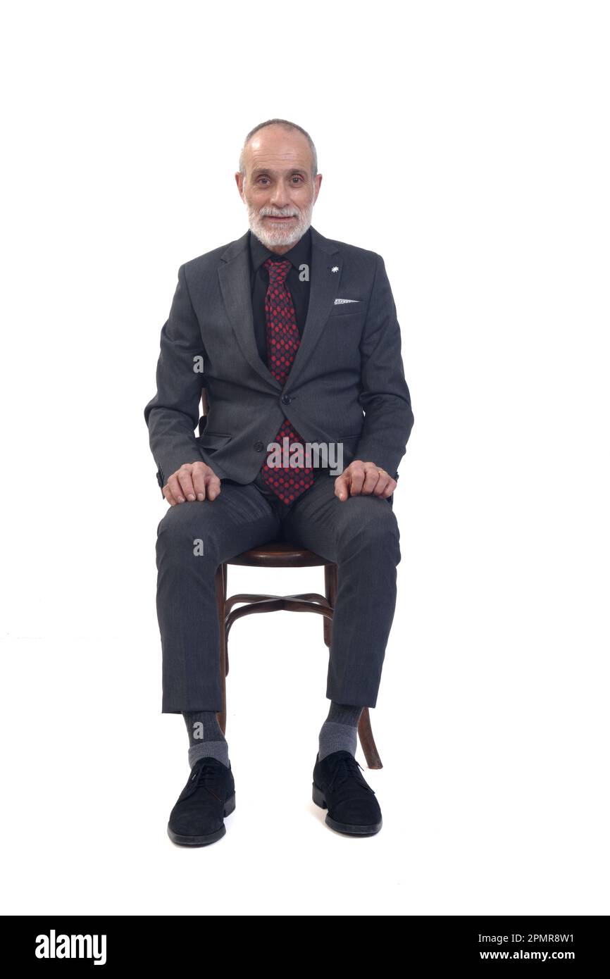 front view of a man sitting on chair with suit and tie on white ...