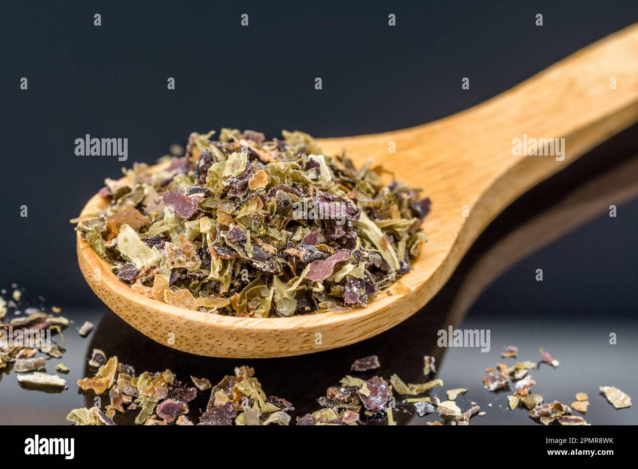 Bamboo spoon with milled dried seaweed - to be used as a savoury spicy ...