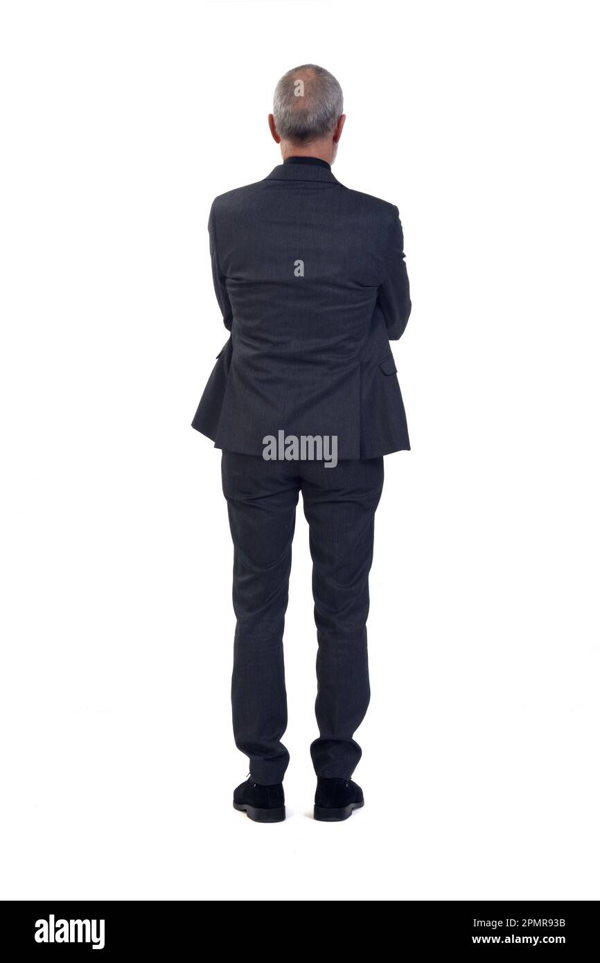 back view of a man standing with suit and arms crossed on white ...