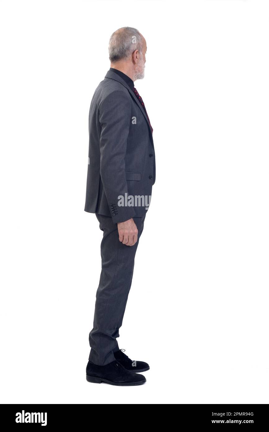 side view of a man standing with suit and tie and look at the bottom on ...