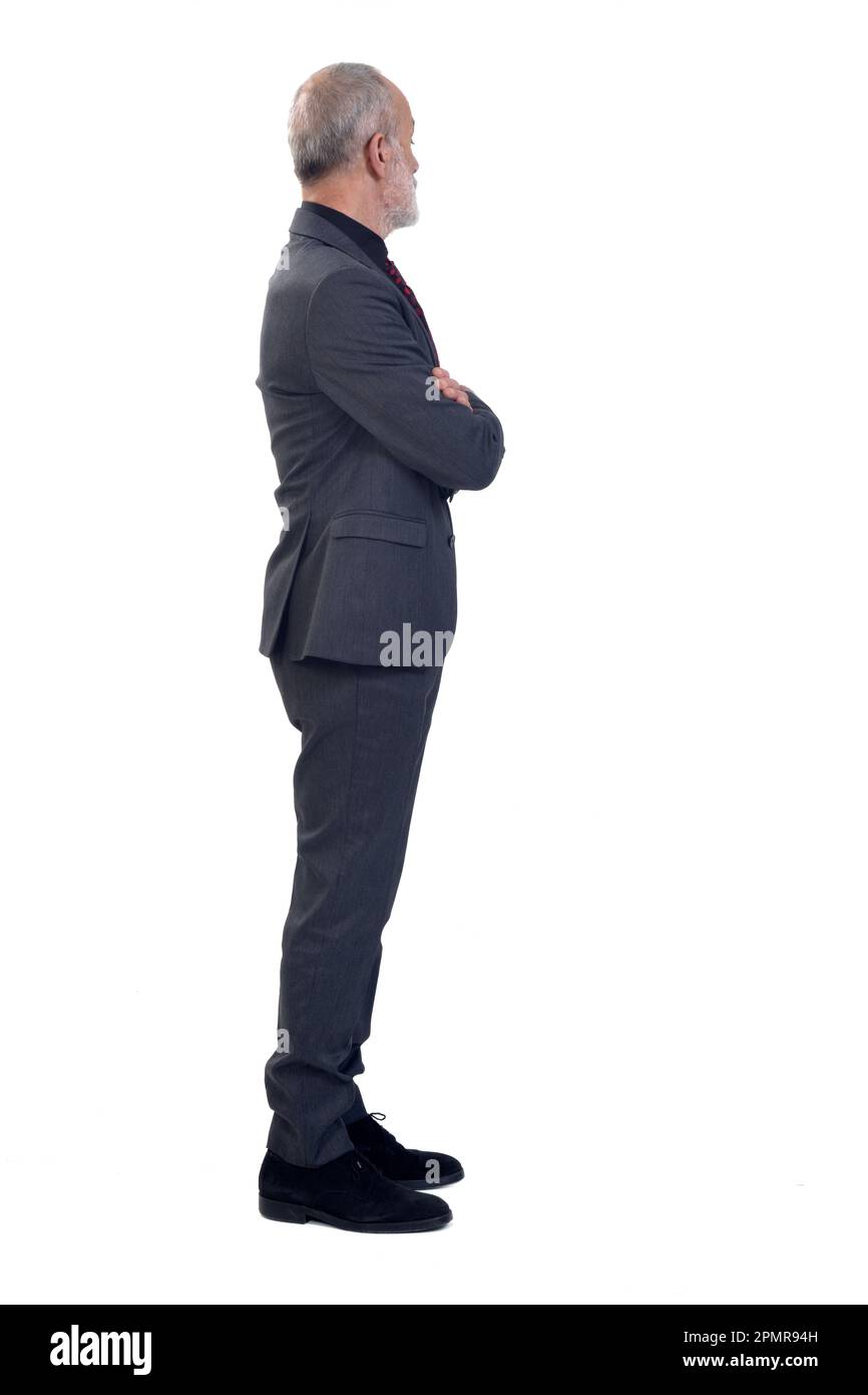 side view of a man standing with suit and tie and look at the bottom ...