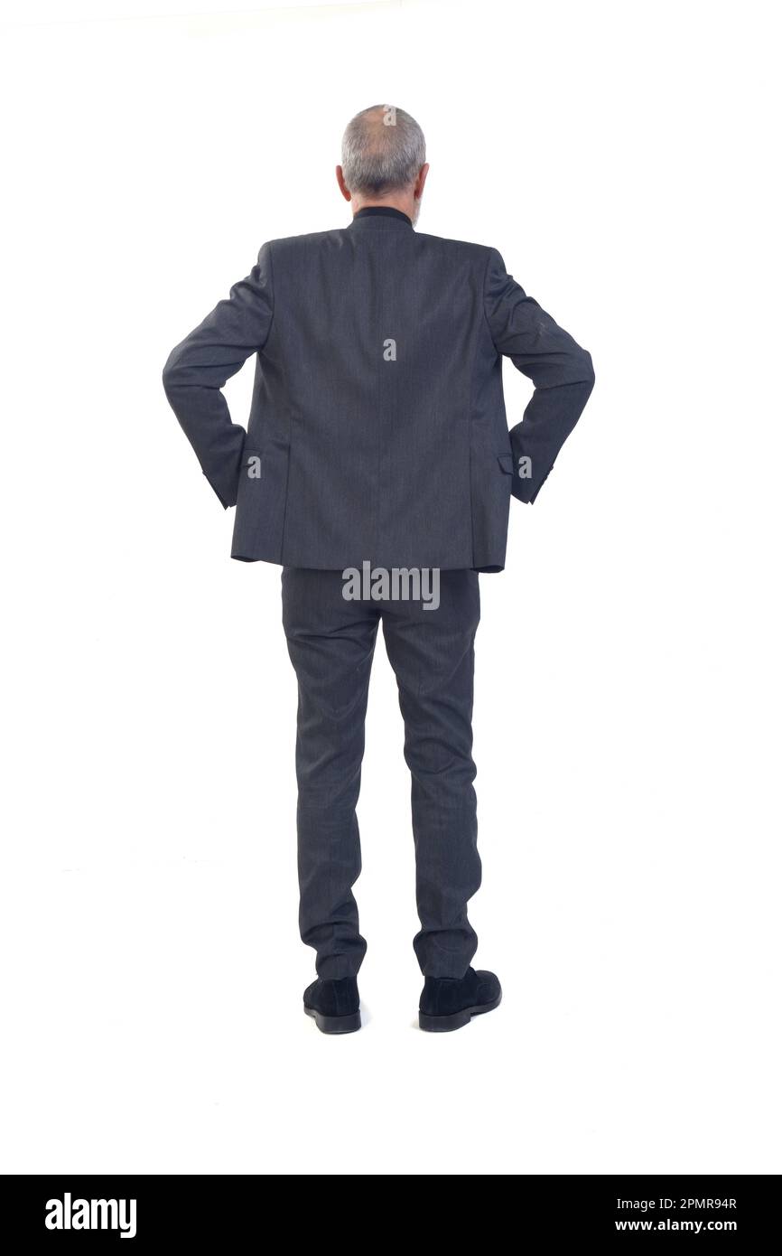 back view of a man standing with suit and tie and arms akimbo on white ...