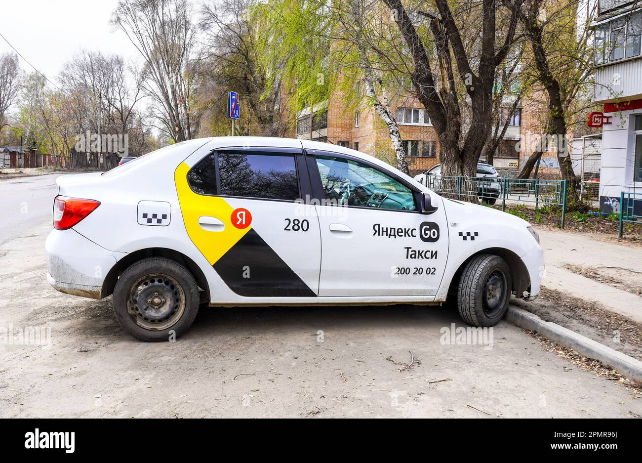 Samara, Russia - April 12, 2023: Yandex Taxi cab is parked on a city ...
