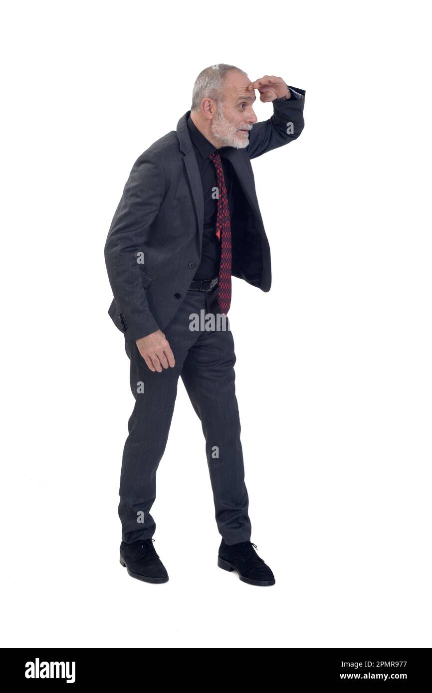 side view of standing man looking away with hand on forehead on white ...