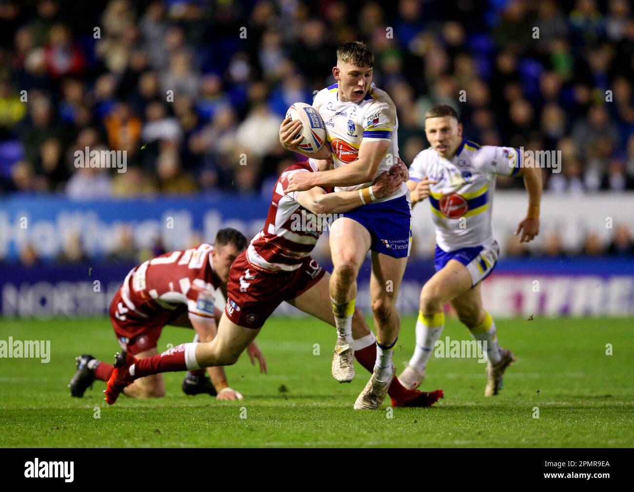 Warrington Wolves' Matty Nicholson is tackled by Wigan Warriors' Jake ...