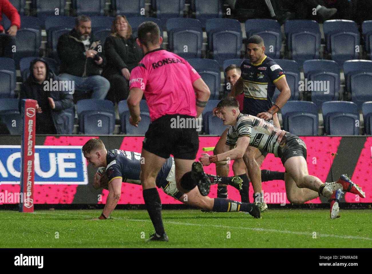 Tom Holroyd #18 of Leeds Rhinos goes over for a try and makes the score ...