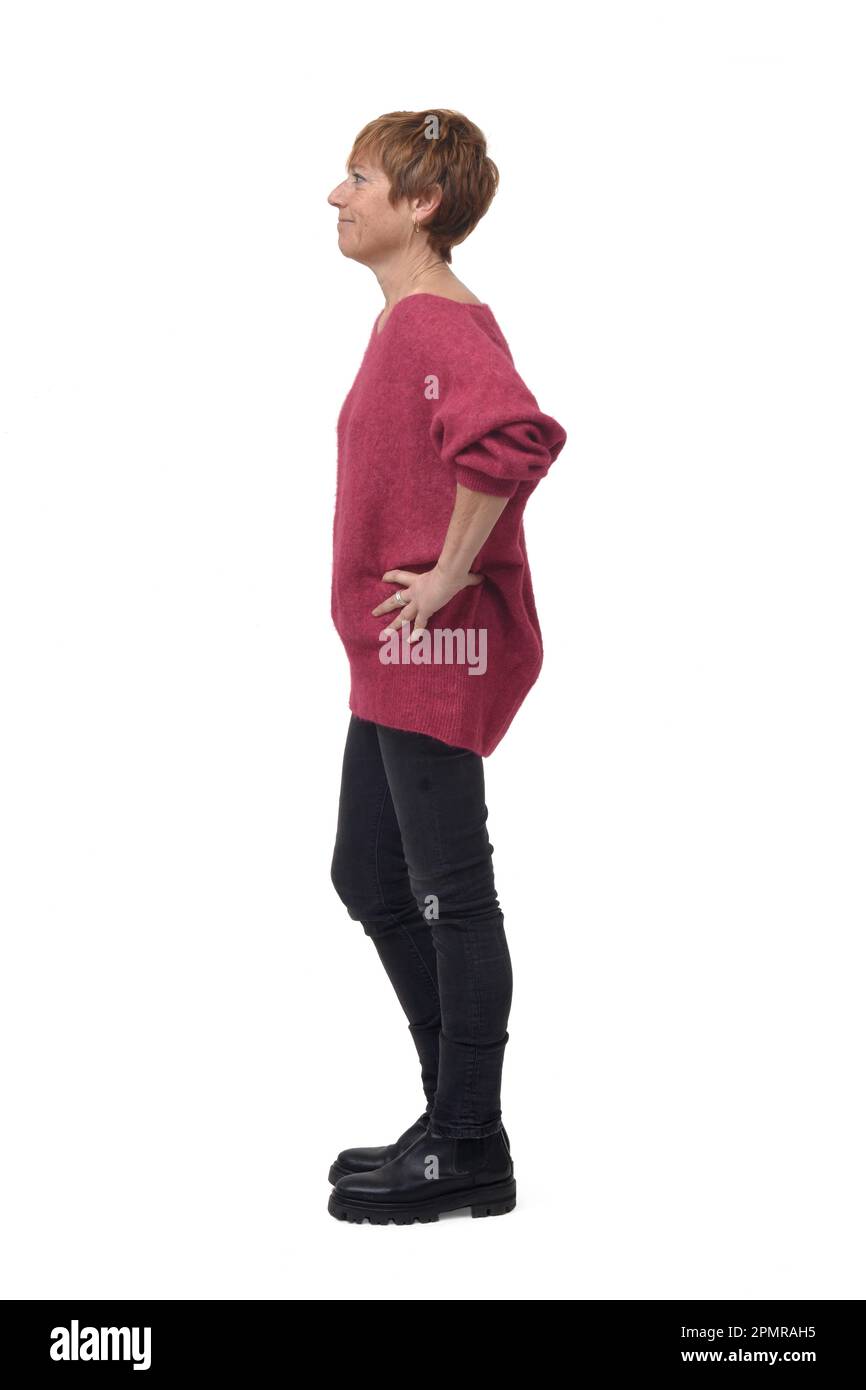 side view of afull length portrait of woman standing in tight jean ...