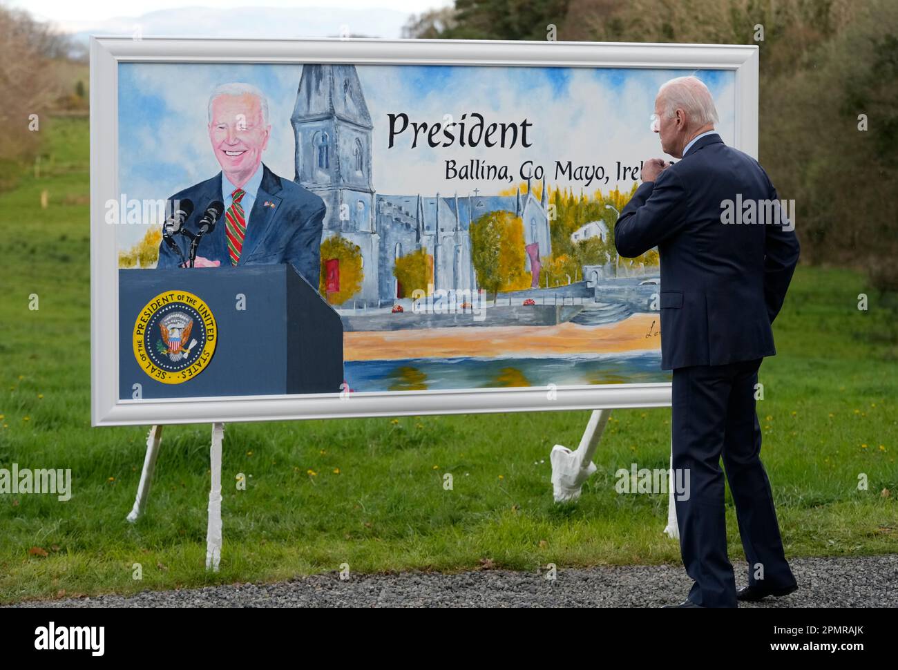 President Joe Biden looks at billboard with his likeness on it during a ...