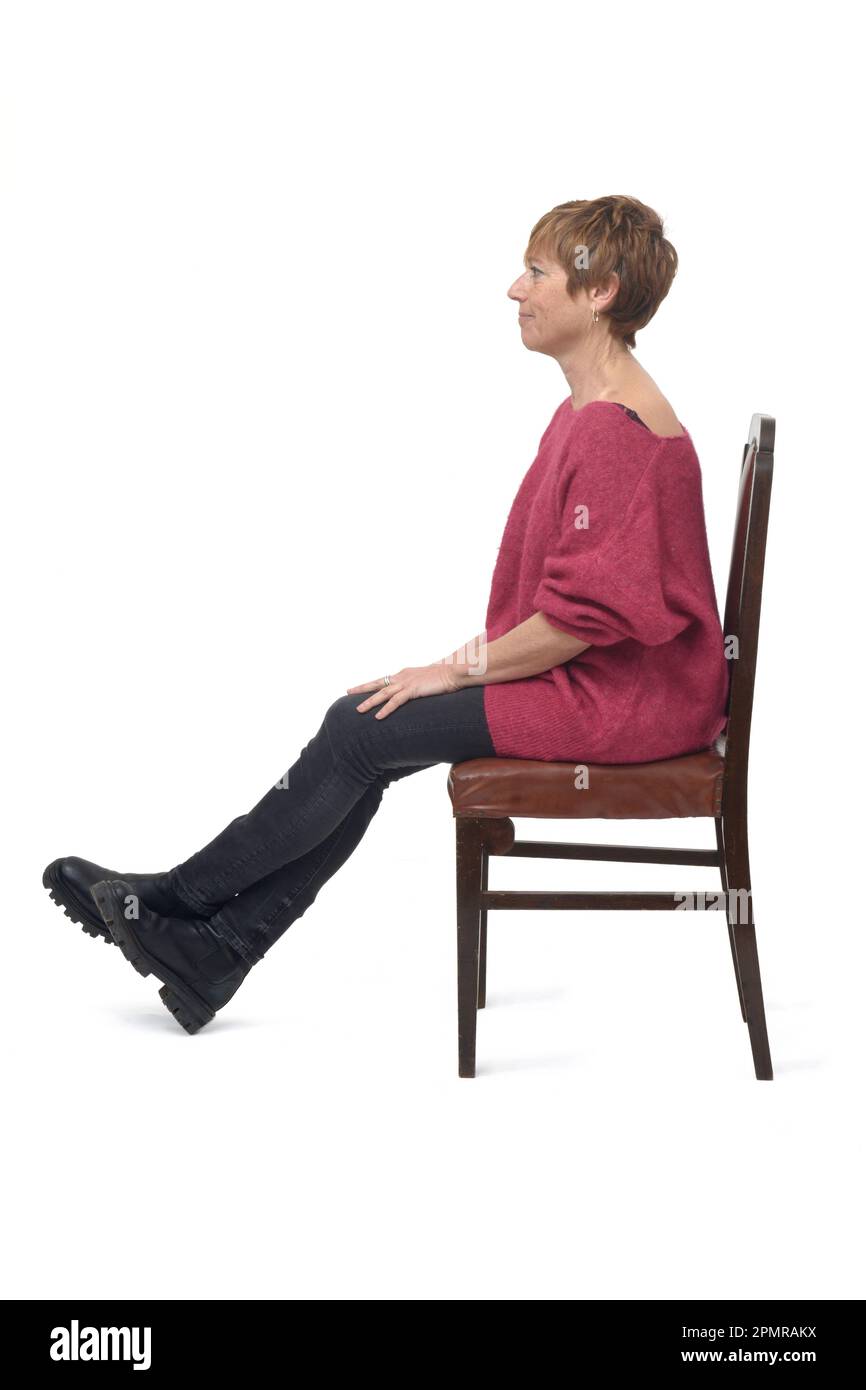 side view of a woman in tight jean pants sitting on chair relaxed and ...