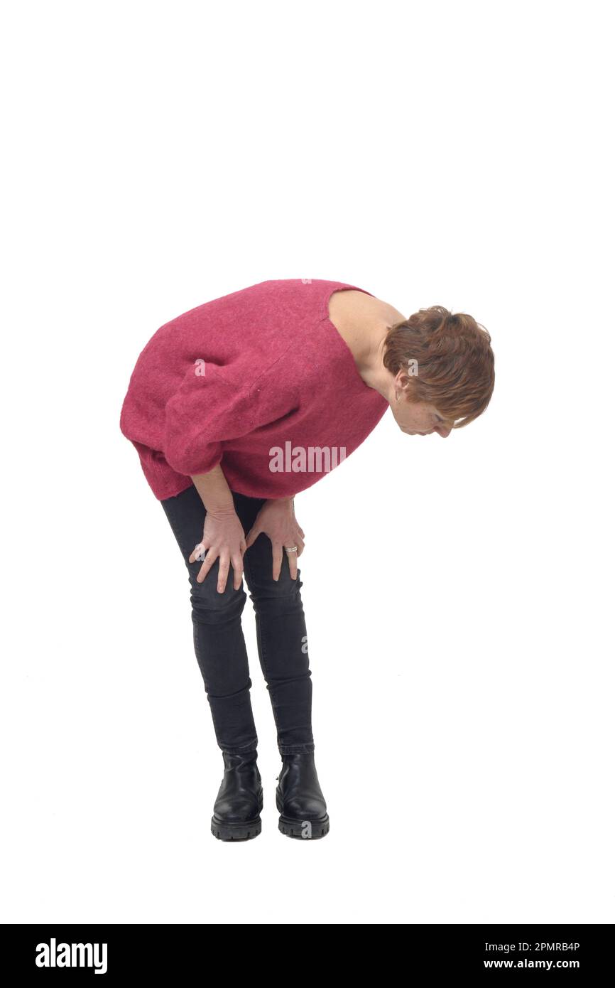 crouched woman looking at the ground to the side looking for something ...