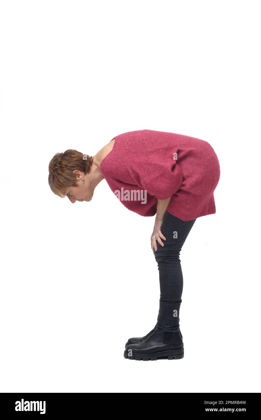 side view of a crouched woman looking at the ground searching on white ...