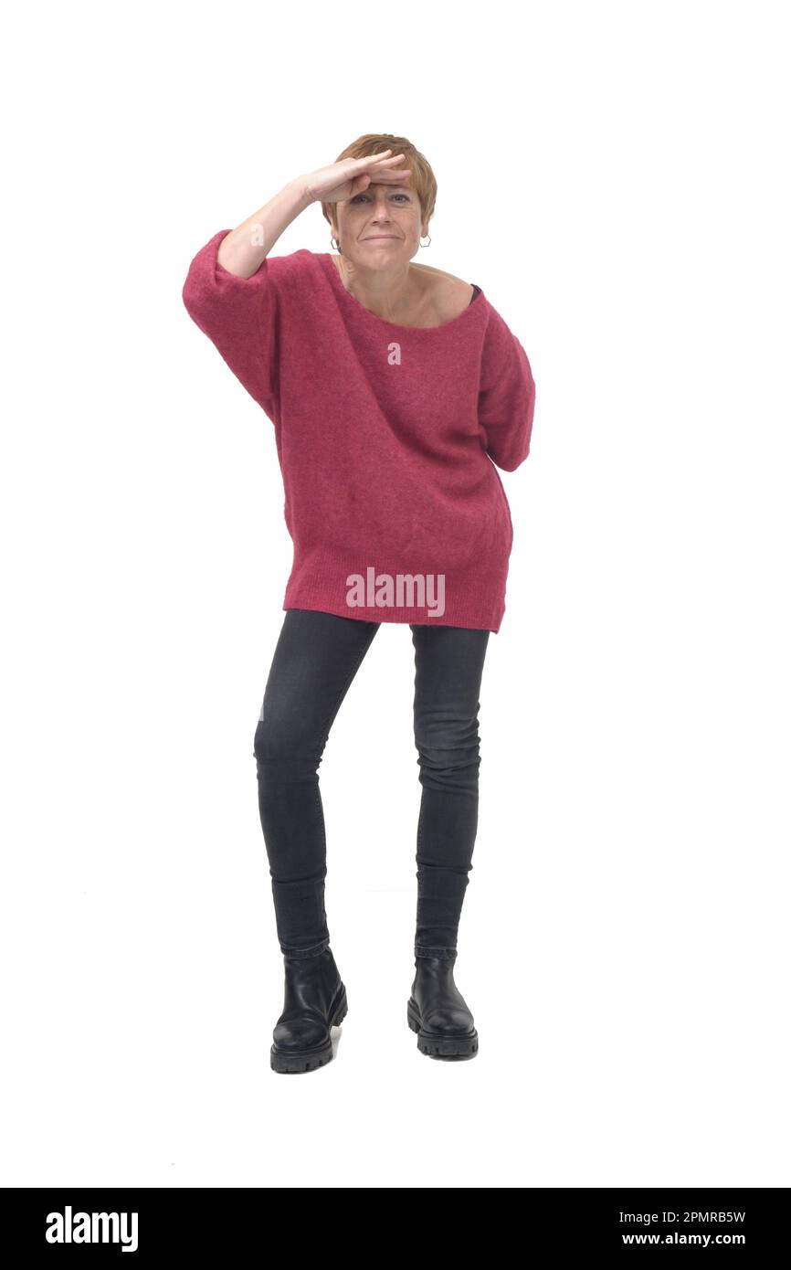 front view of standing woman looking at camera with hand on forehead on ...