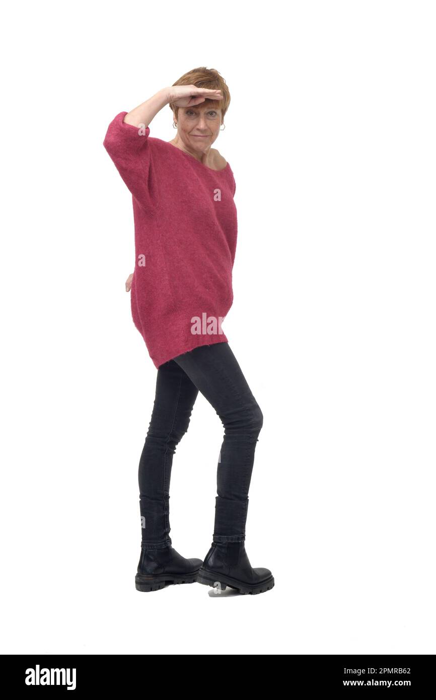 side view of standing woman looking at camera with hand on forehead on ...