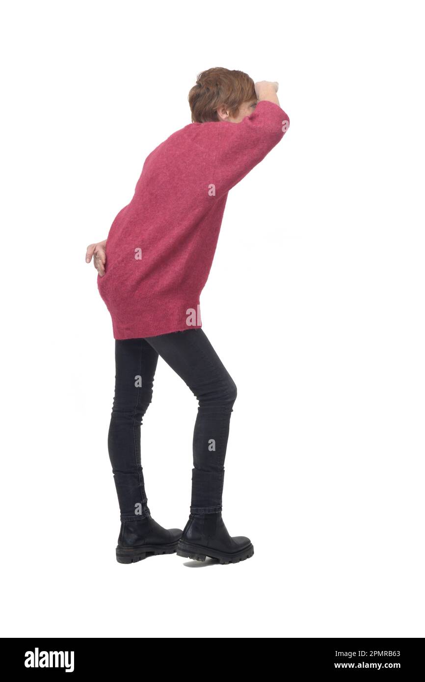 side view of standing woman looking away with hand on forehead on white ...