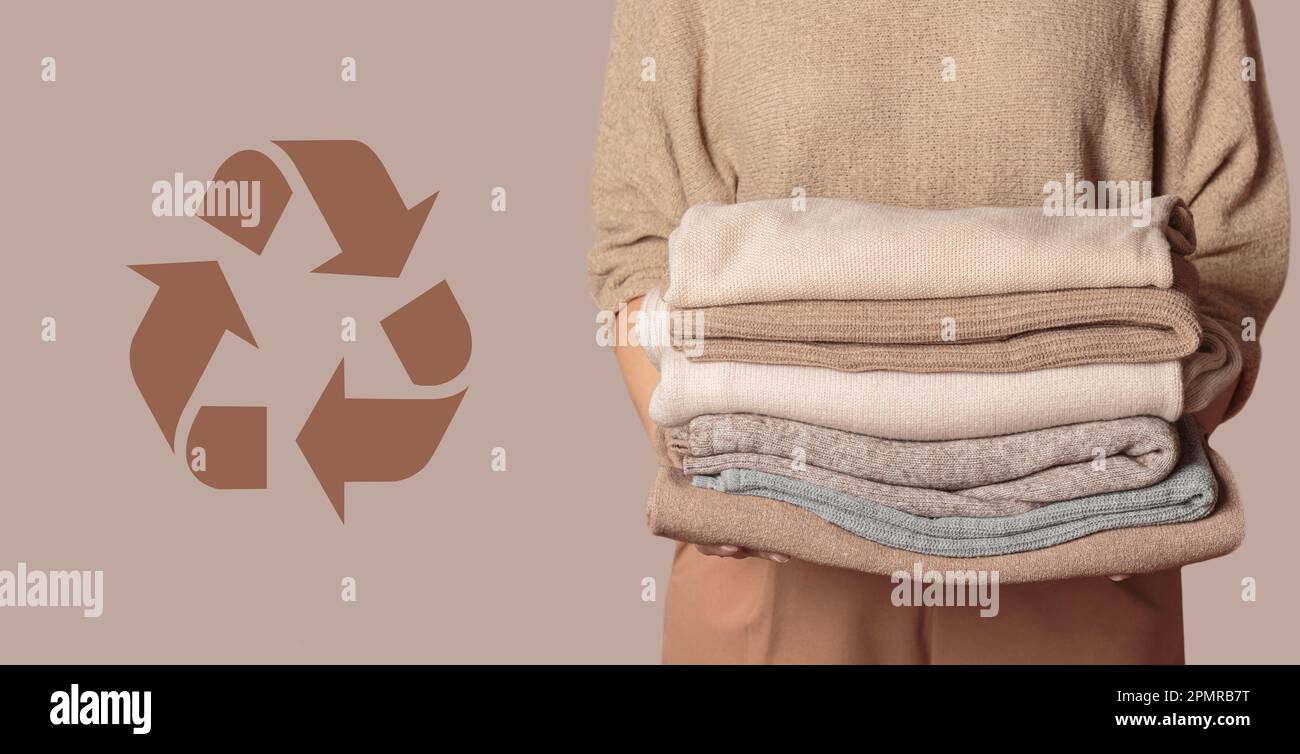 Woman holding stack of clothes with used wardrobe for reuse Stock Photo ...
