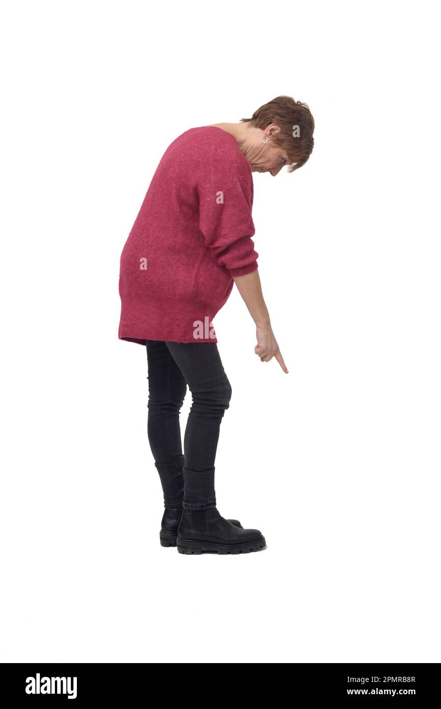 side view of a crouched woman looking at down and pointing finger at ...