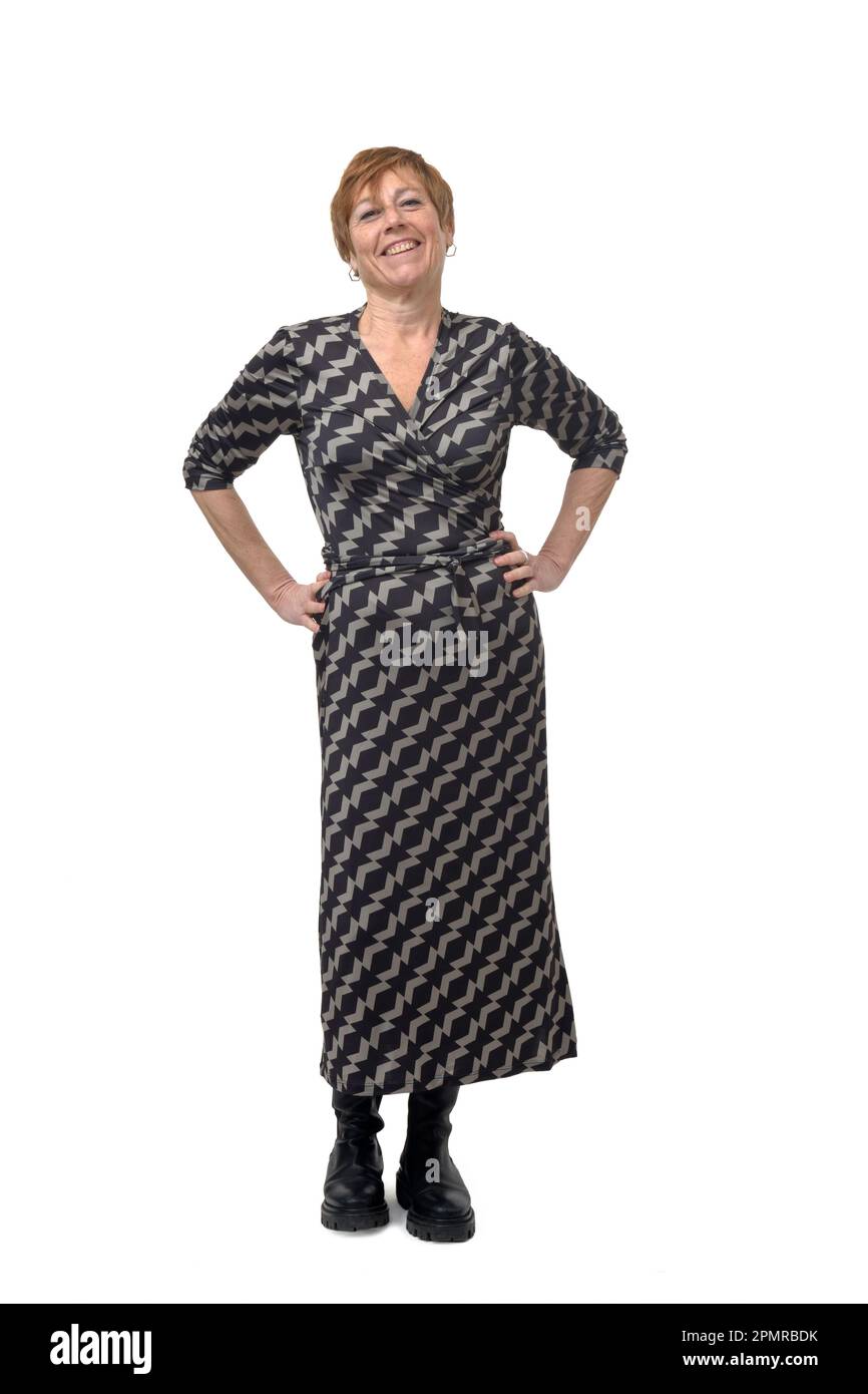 front view of a happy woman with arms akimbo looking at camera on white ...