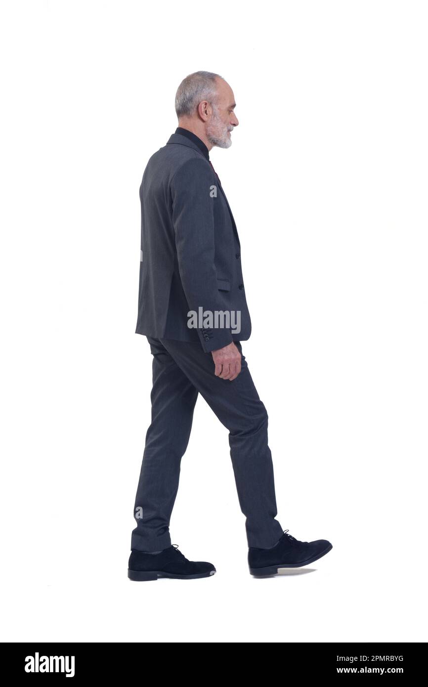 side and back view of a man with suit and tie walking on white ...