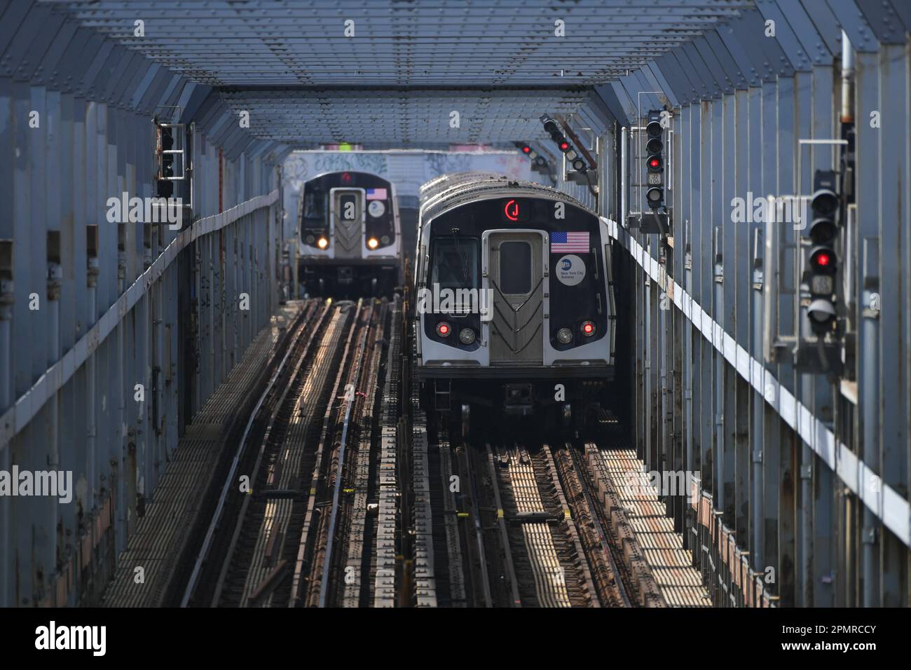 Two subway trains cross over the Williamsburg Bridge on April 14, 2023 in New York City Stock ...