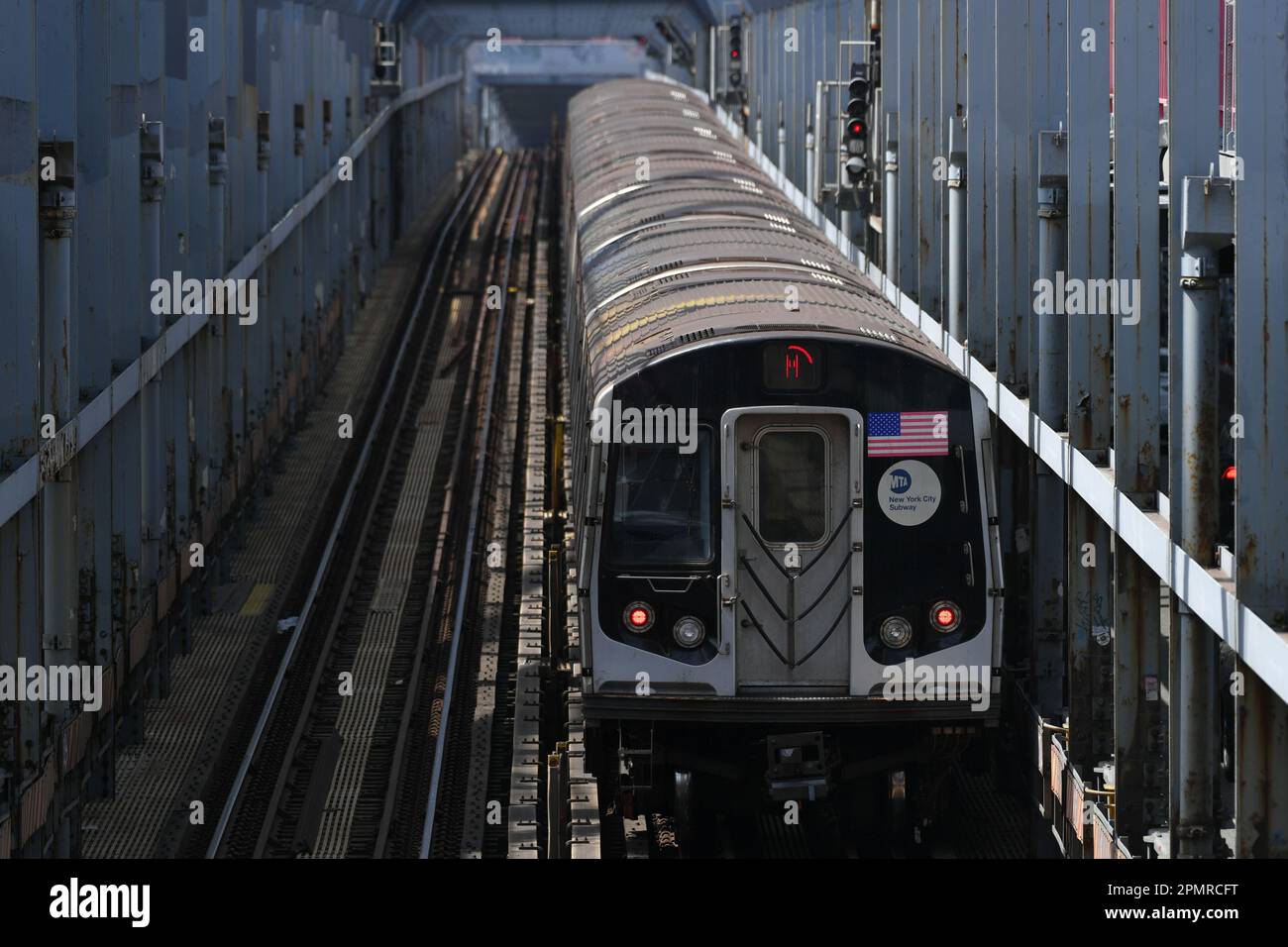 A subway train crosses over the Williamsburg Bridge on April 14, 2023 in New York City Stock ...