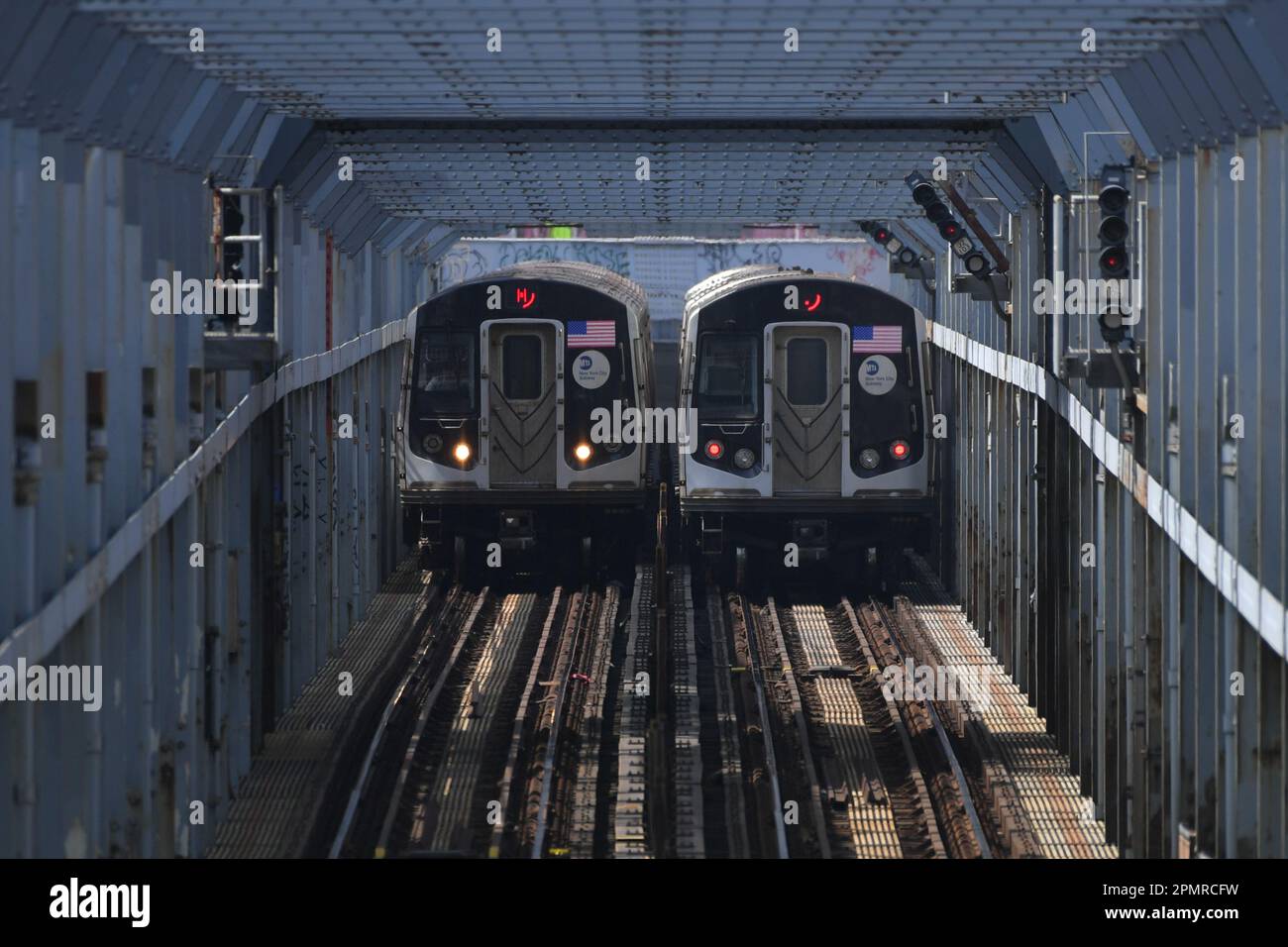 Two subway trains cross over the Williamsburg Bridge on April 14, 2023 in New York City Stock ...