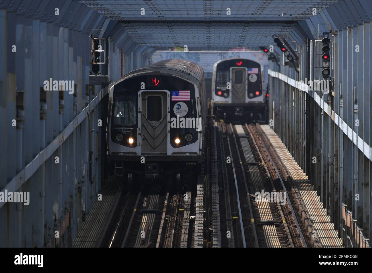 Two subway trains cross over the Williamsburg Bridge on April 14, 2023 in New York City Stock ...