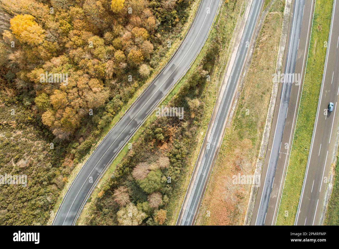 An aerial view of a long, straight, and empty multi-lane highway ...