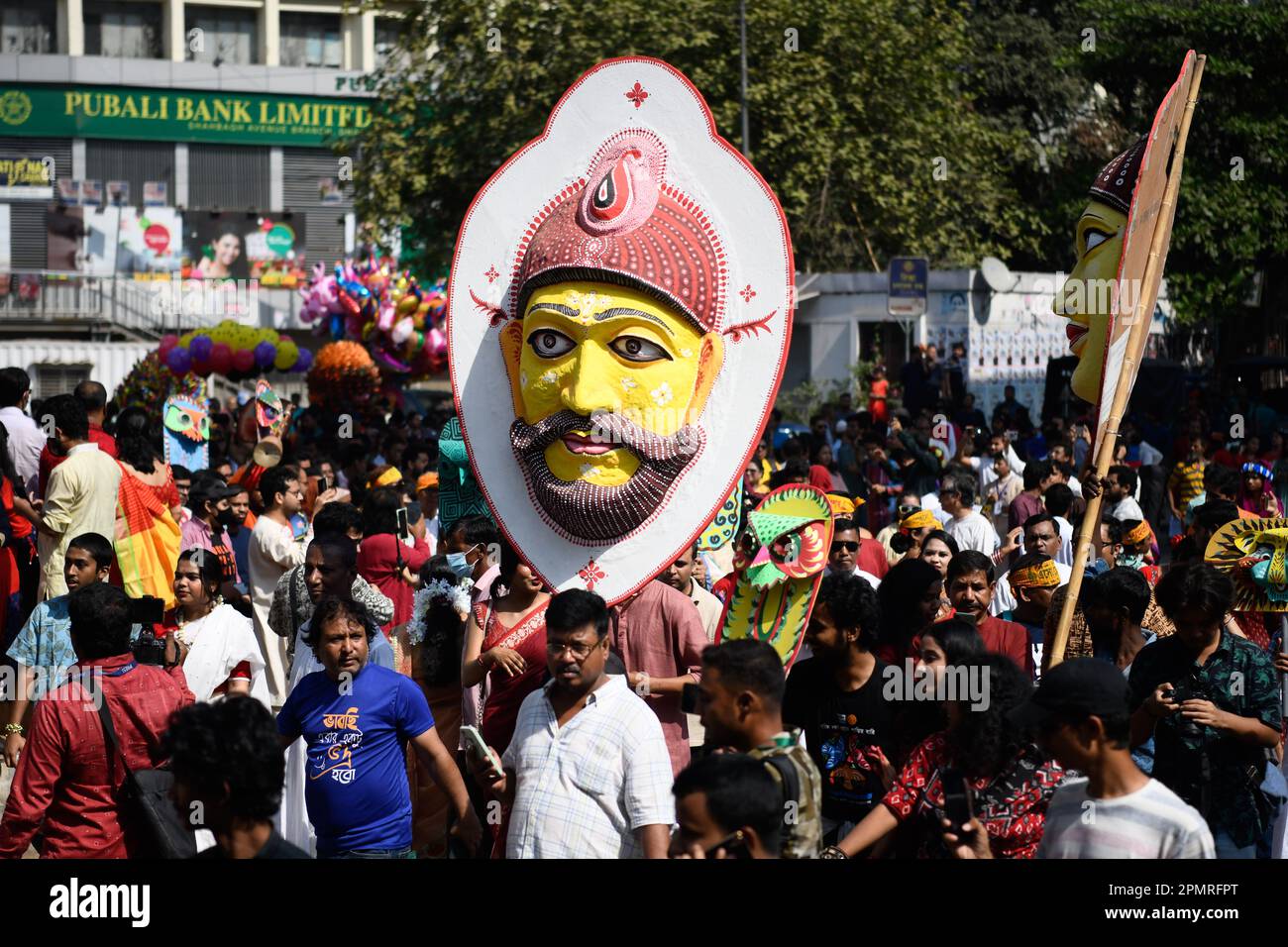 Bangladeshi people participate in a colorful rally holding with a ...