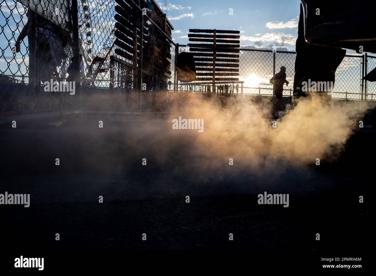 Seattle, USA. 22 Mar, 2023. Smoke coming out of a car exhaust at sunset ...
