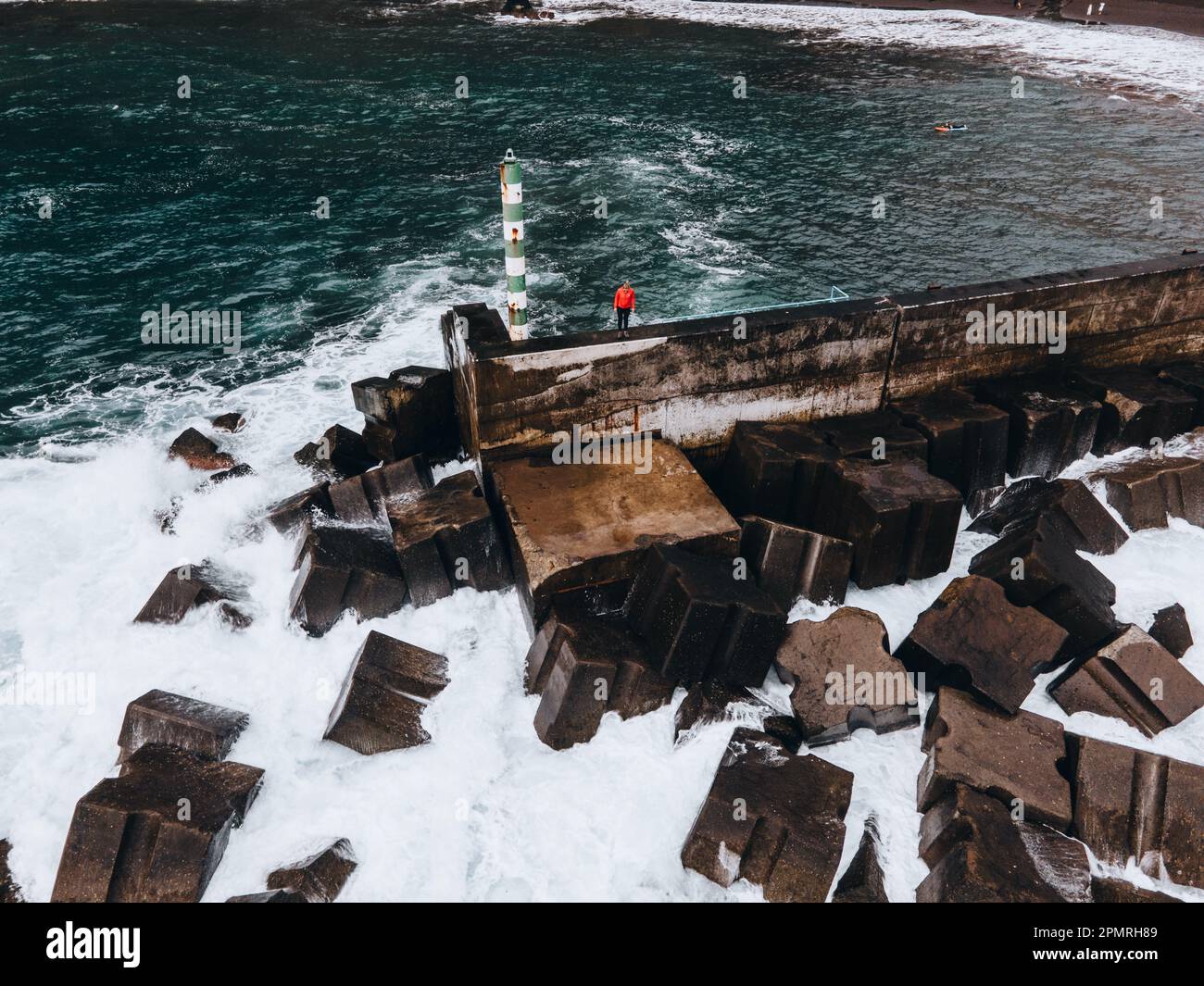 Drone view of waves crashing at Seixal Pier in Madeira, Portugal Stock ...