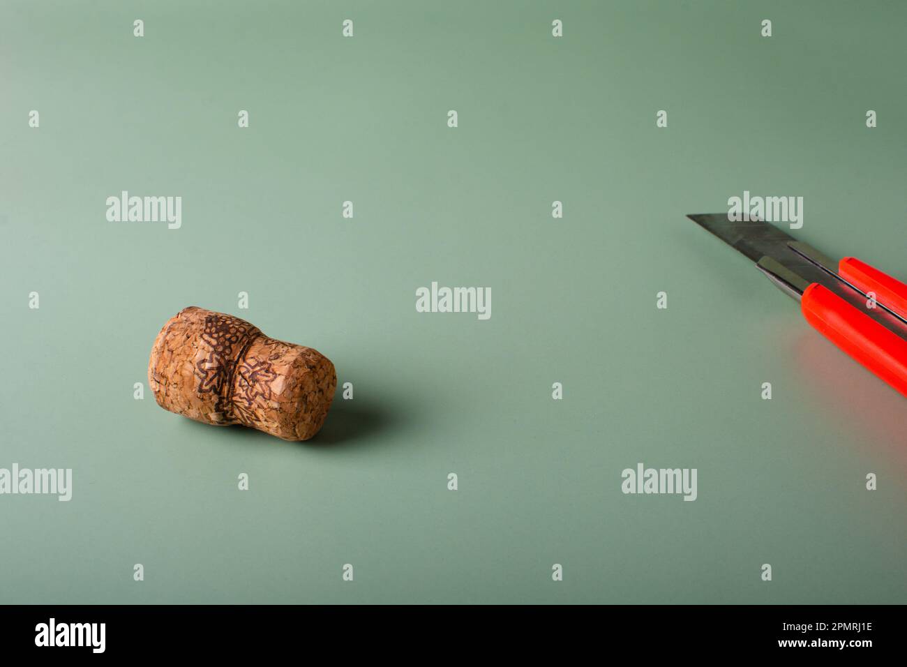 A man's hand holds cut corks and cuts them. Preservation of the planet ...