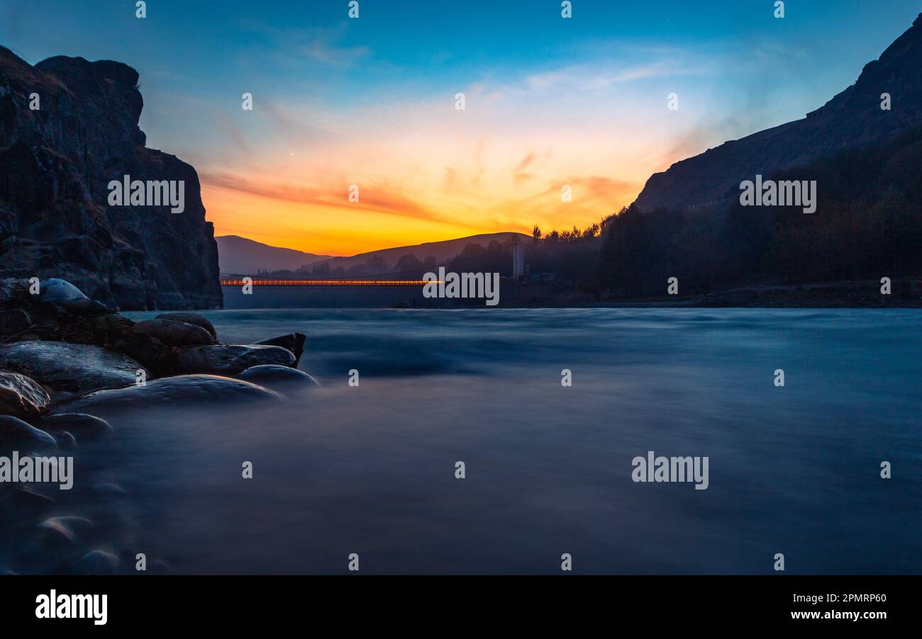 A long shutter photo of Kokcha river in a sunset with blue sky ...