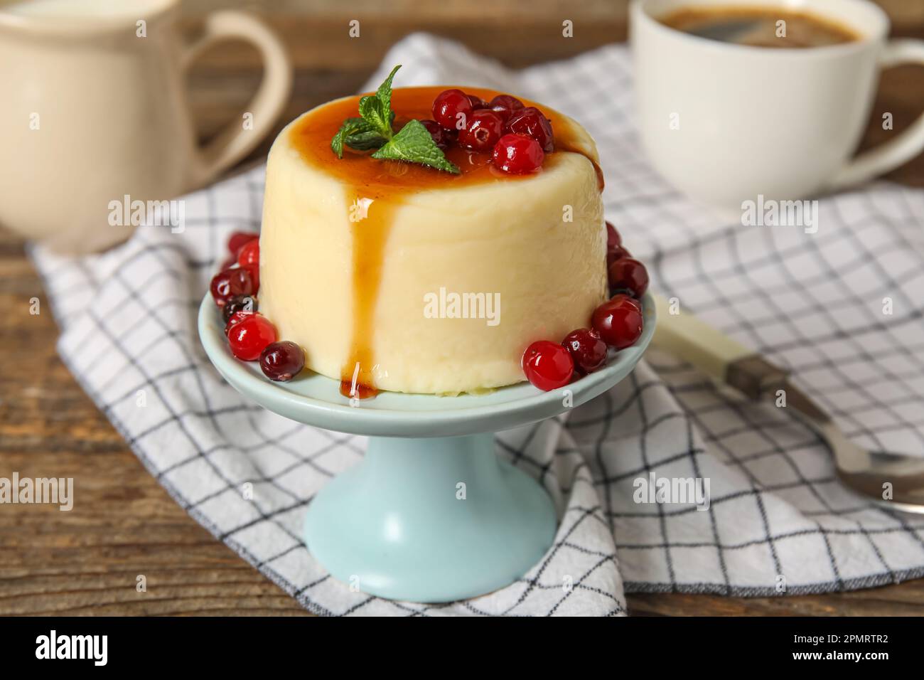 Dessert stand with delicious pudding, mint and cranberries covered by ...