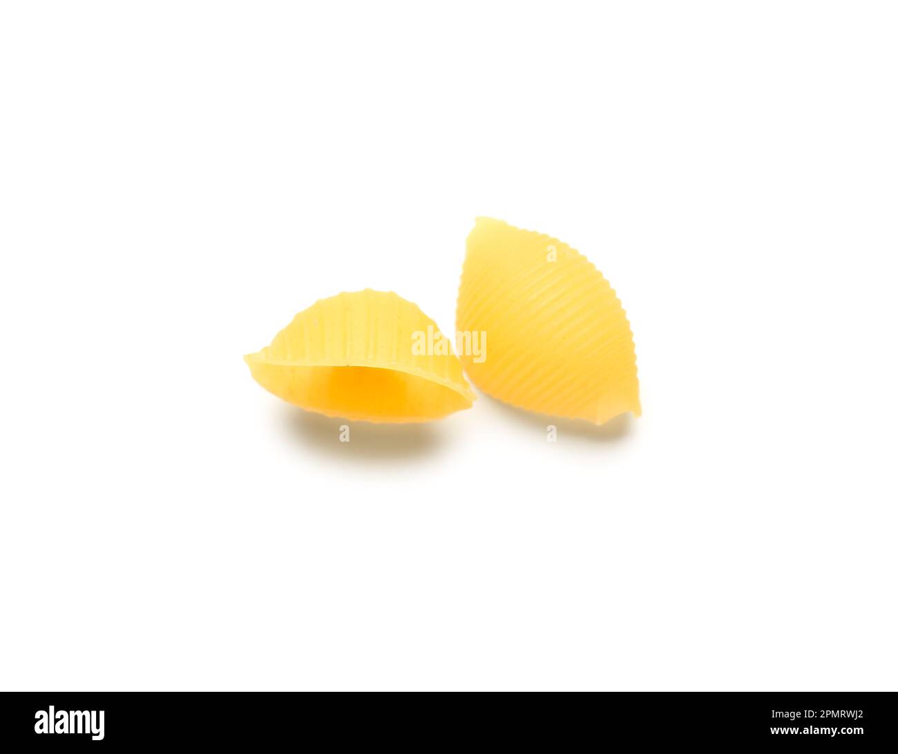 Raw conchiglie pasta isolated on white background Stock Photo - Alamy