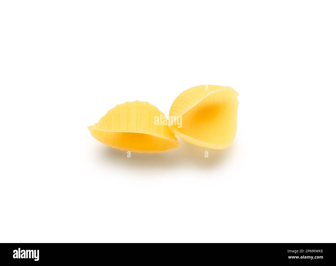 Raw conchiglie pasta isolated on white background Stock Photo - Alamy