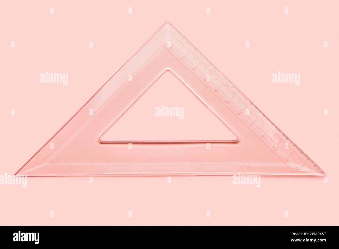 Transparent triangle plastic ruler on pink background Stock Photo - Alamy